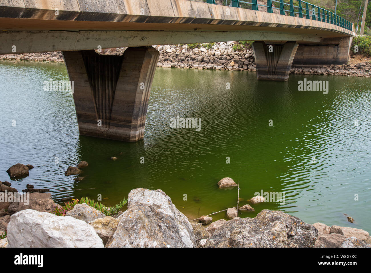 River with green water passing under a bridge Stock Photo - Alamy
