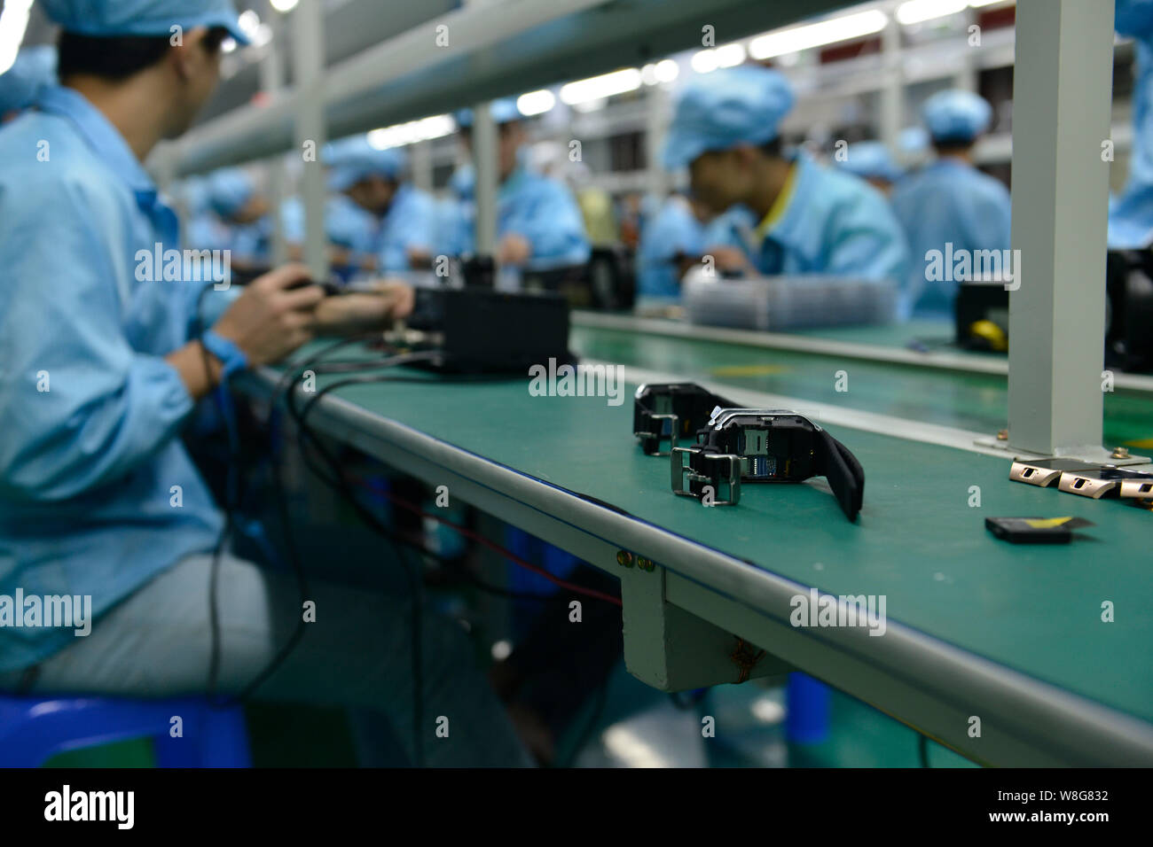 --FILE--Chinese workers assemble smart watches on the assembly line at ... --FILE--Chinese workers assemble smart watches on the assembly line at ...
