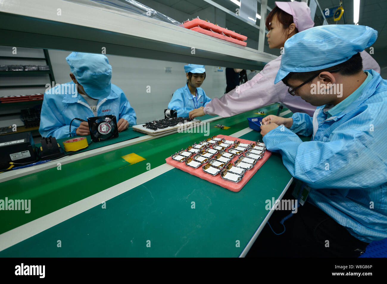 --FILE--Chinese workers assemble smart watches on the assembly line at ... --FILE--Chinese workers assemble smart watches on the assembly line at ...
