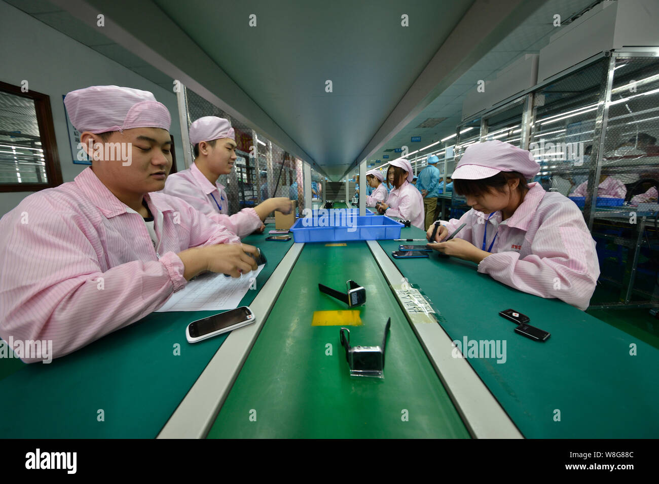 --FILE--Chinese workers assemble smart watches on the assembly line at ...