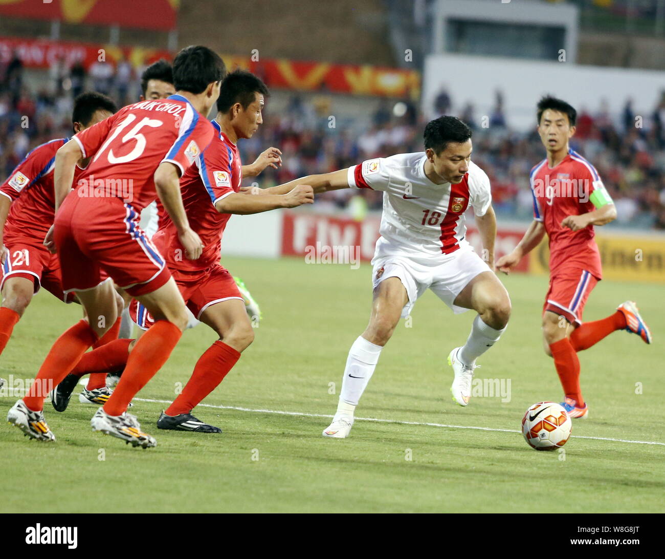 Gao Lin of China, second right, challenges footballers of North Korea ...