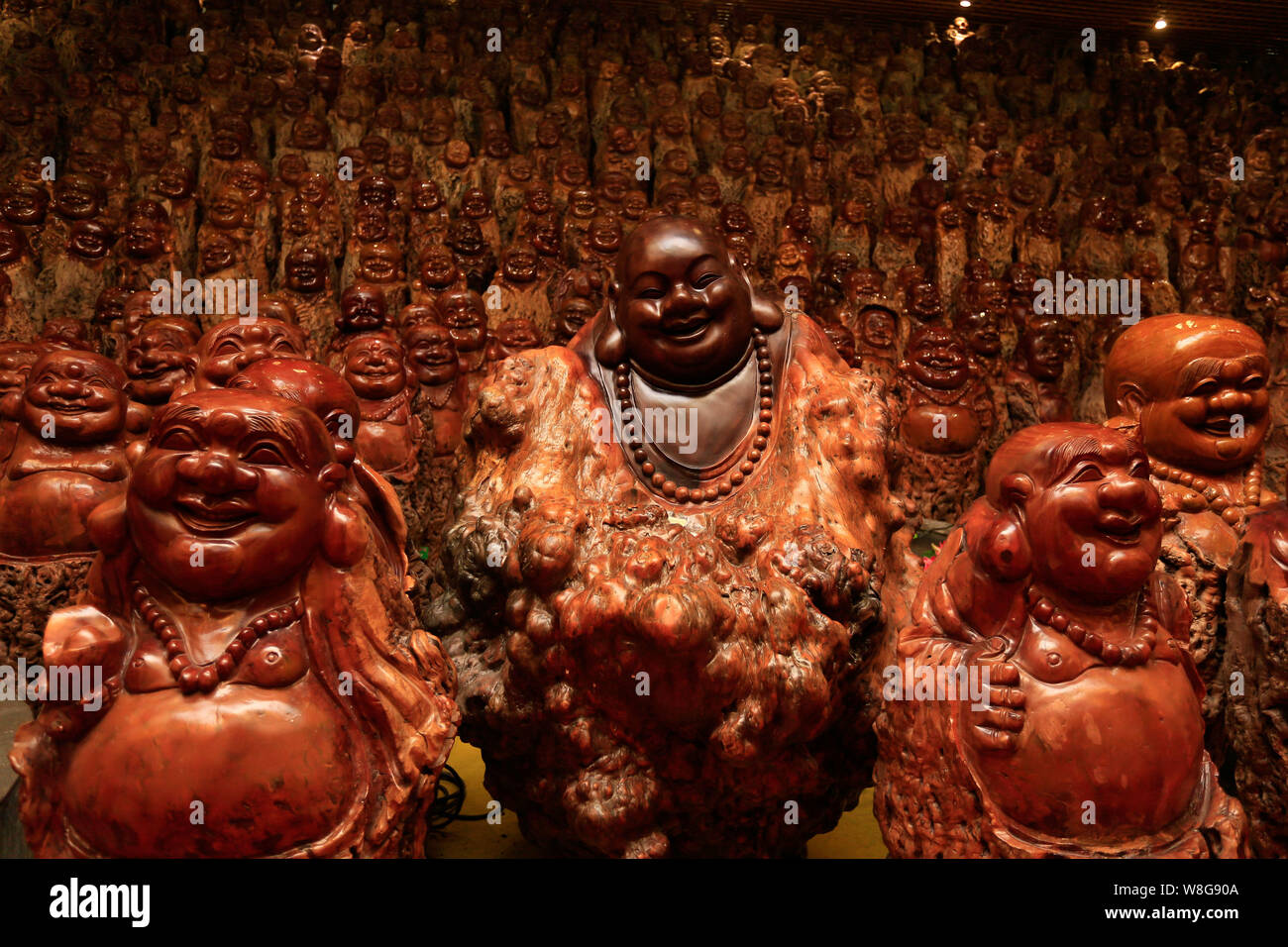 Wooden Buddha statues are on display at an exhibition center in ...