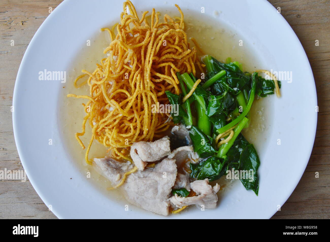 crispy yellow noodle with Chinese kale and pork in gravy sauce Stock ...