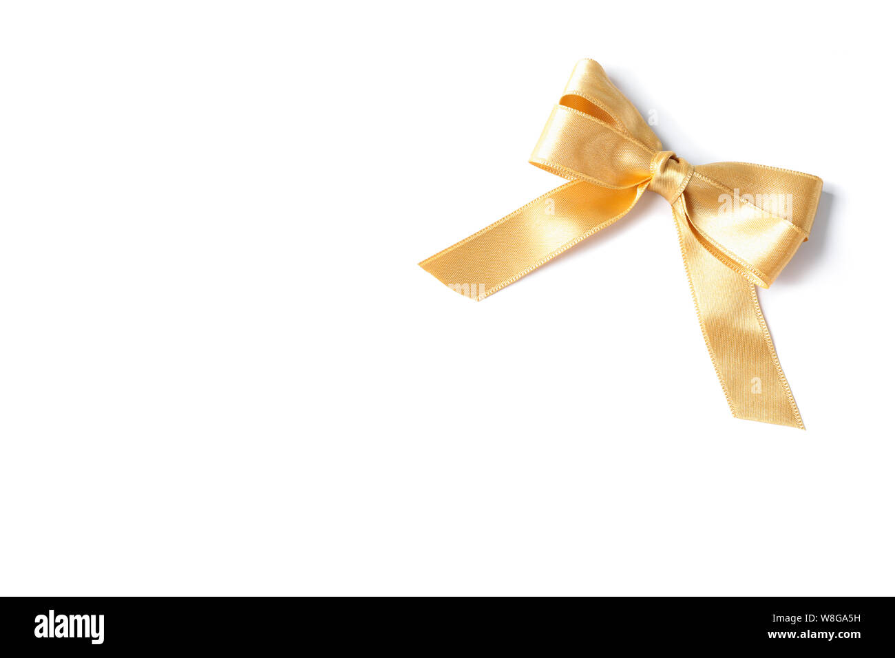 Gold bow isolated on white background. Gift concept Stock Photo - Alamy