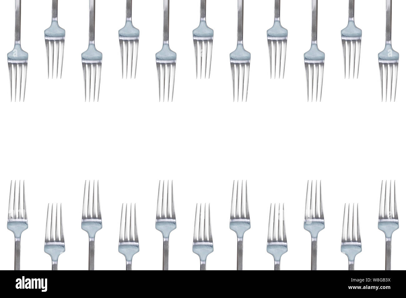 A lot of silver shiny forks. Isolated white background. Concept copy ...