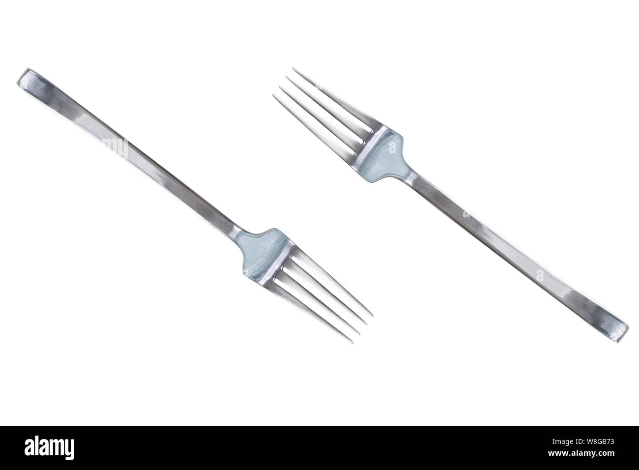Two shiny forks. Isolated white background. Concept design. Copy space ...