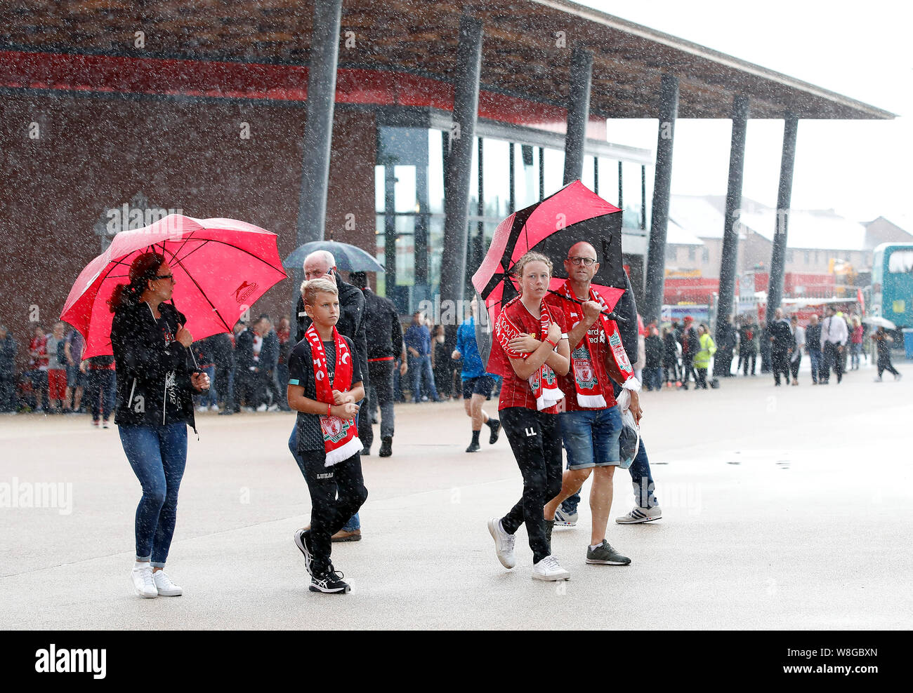 Fans arriving early are caught in the rain before the Premier League ...