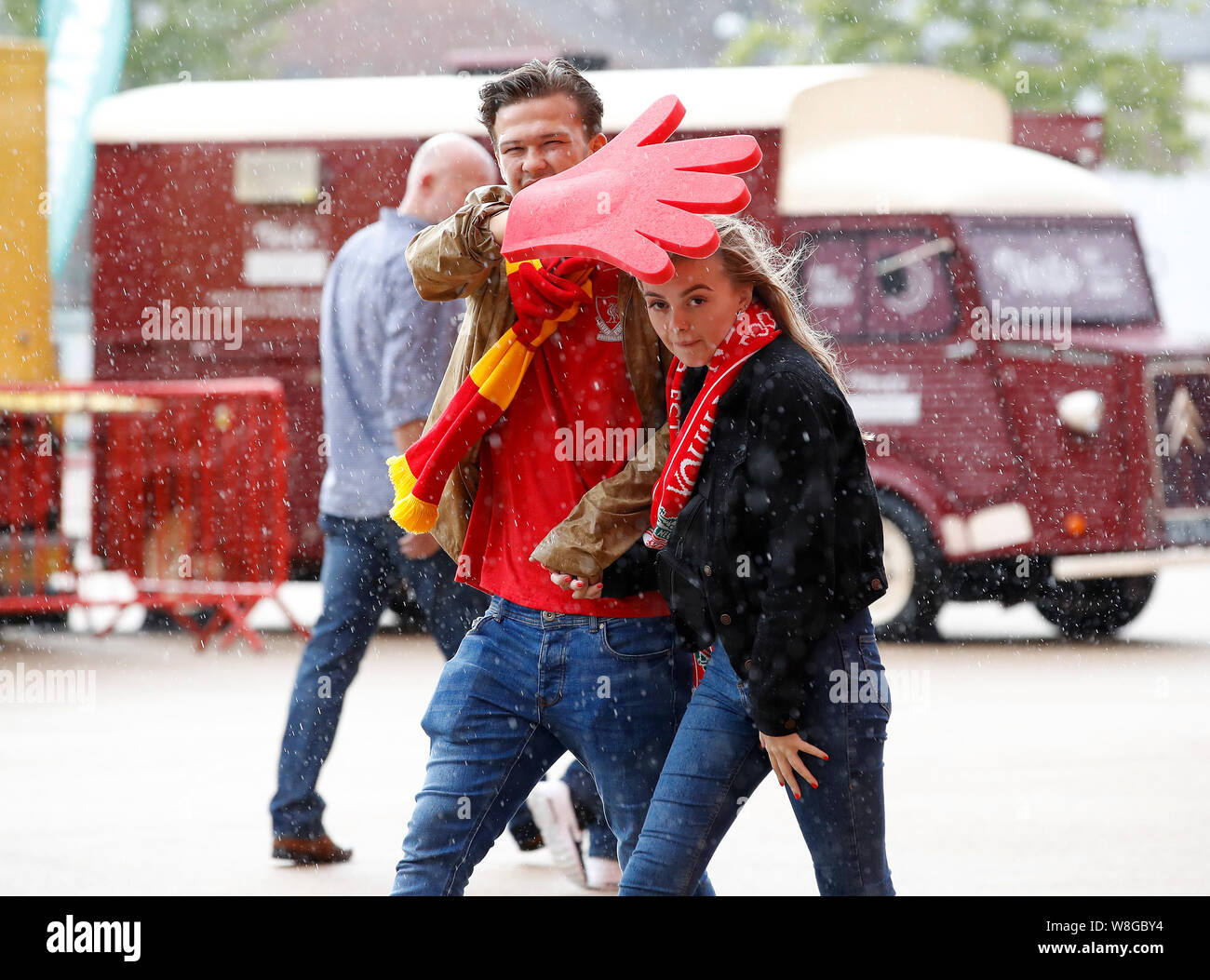 Fans arriving early are caught in the rain before the Premier League ...