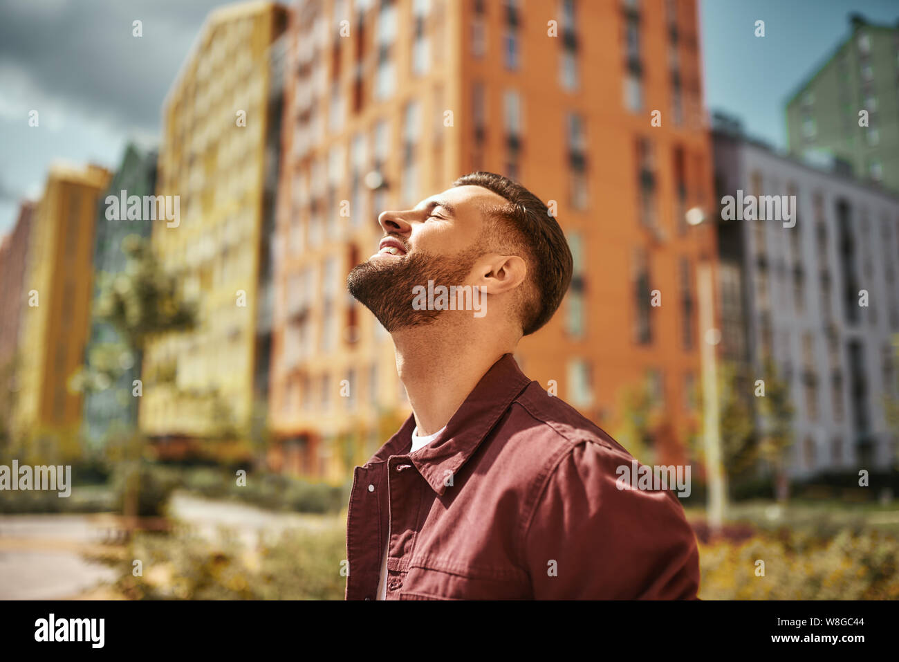 Feeling so happy Side view of positive attractive man with stubble ...