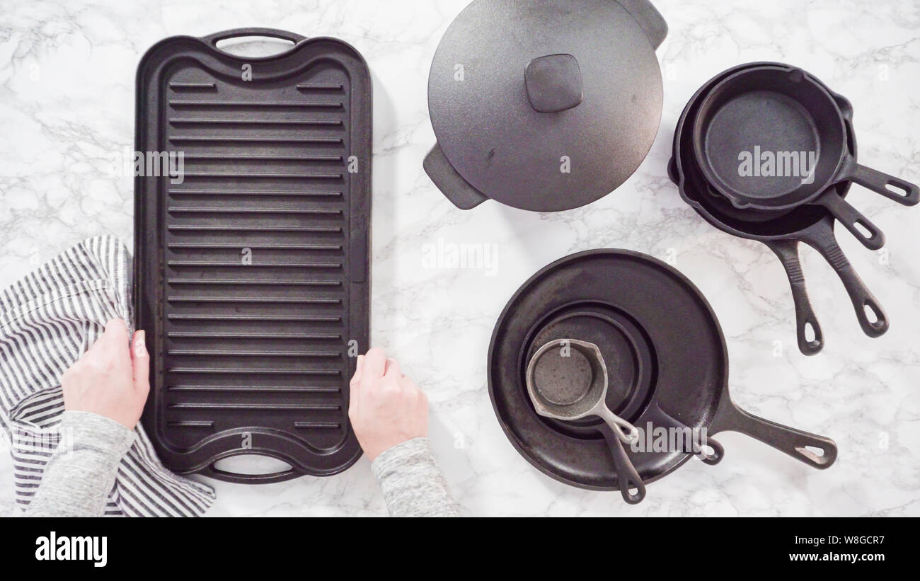 Flat lay. Variety of cast iron kitchenware on a marble countertop Stock ...