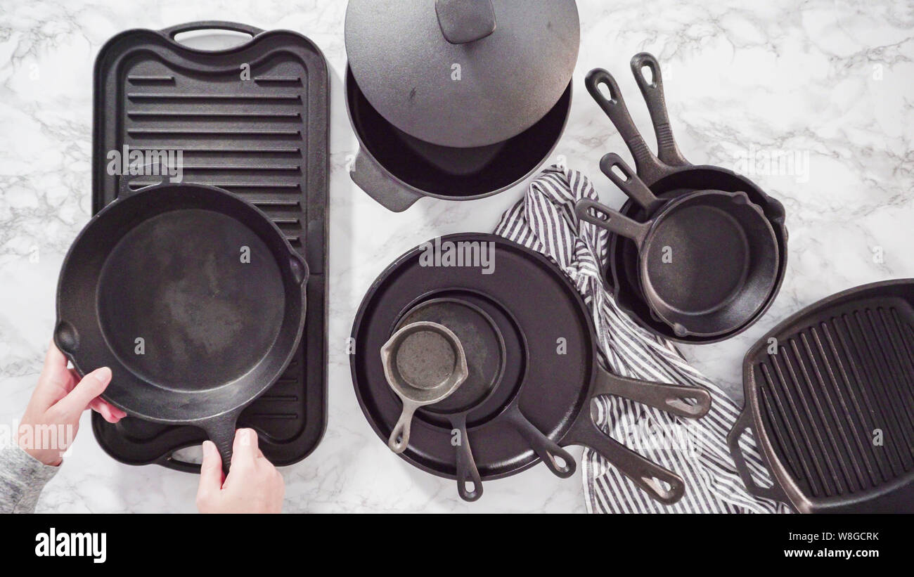 Flat lay. Variety of cast iron kitchenware on a marble countertop Stock ...