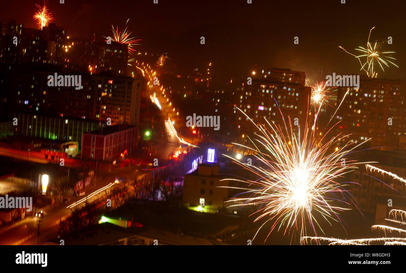 Fireworks explode over a residential area for Spring Festival to ...