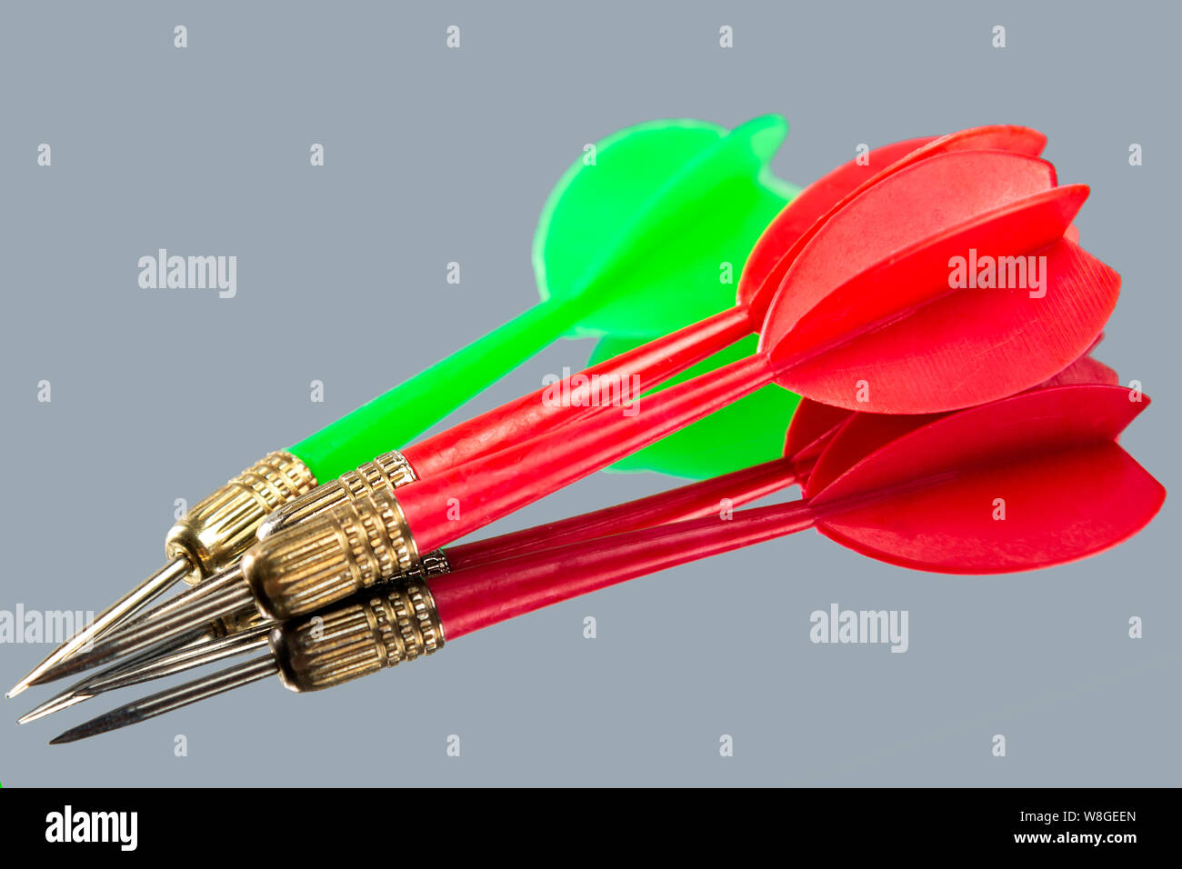 Red and green darts on a mirror background. Hit the target Stock Photo ...