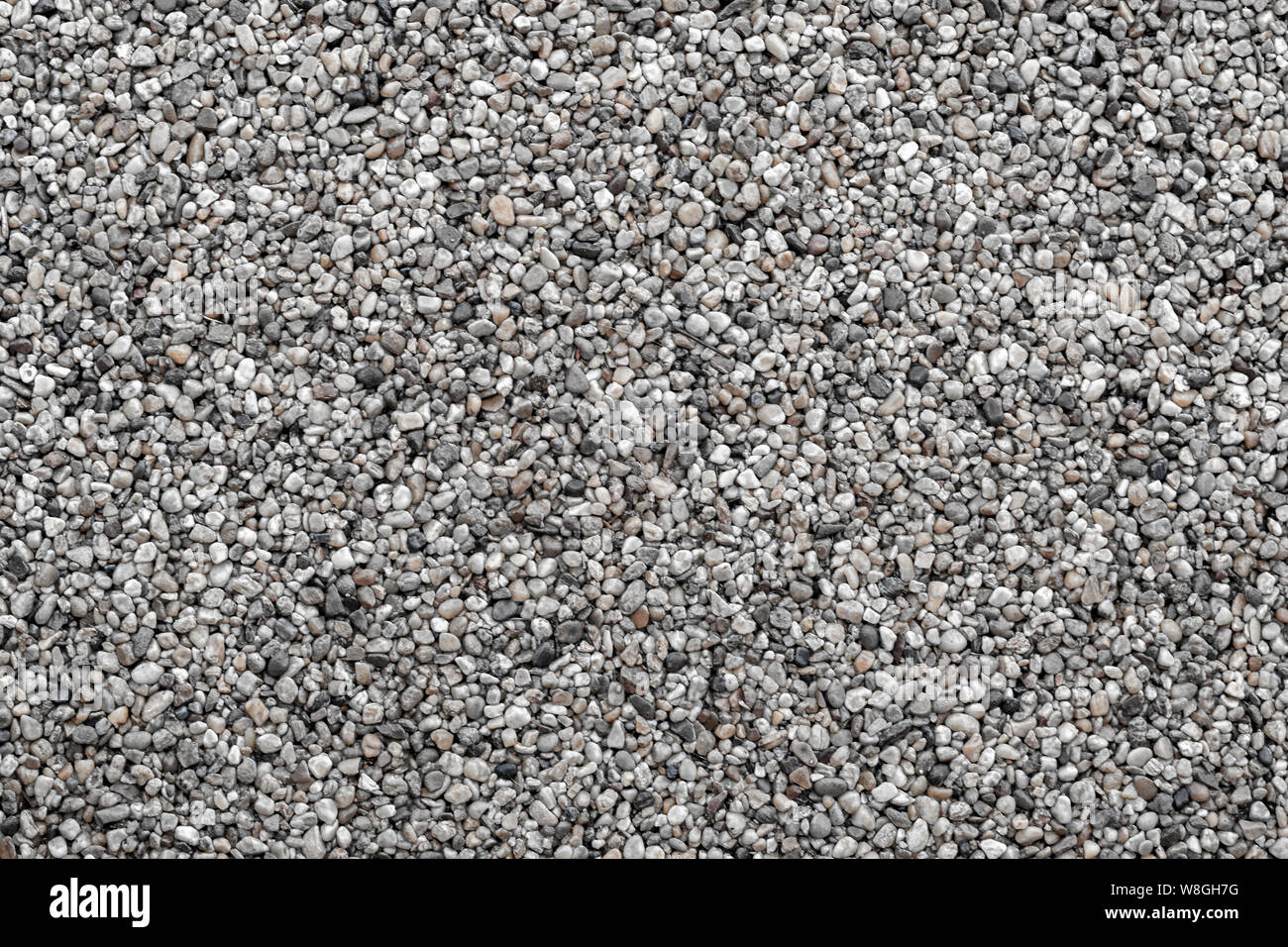 Gray stone texture. Frame filled with small round stones glued with ...