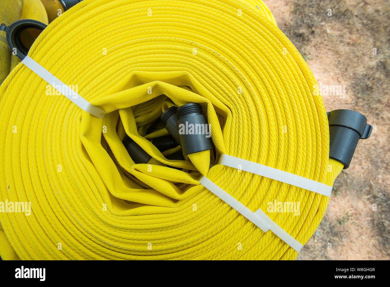 Rolled up fire hose hi-res stock photography and images - Alamy