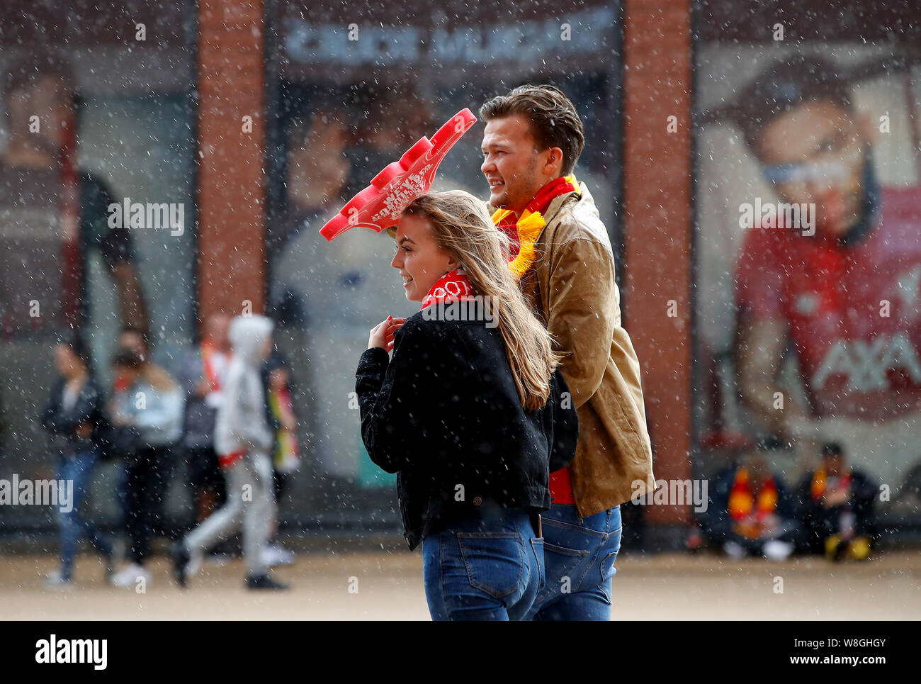 Fans arriving early are caught in the rain before the Premier League ...