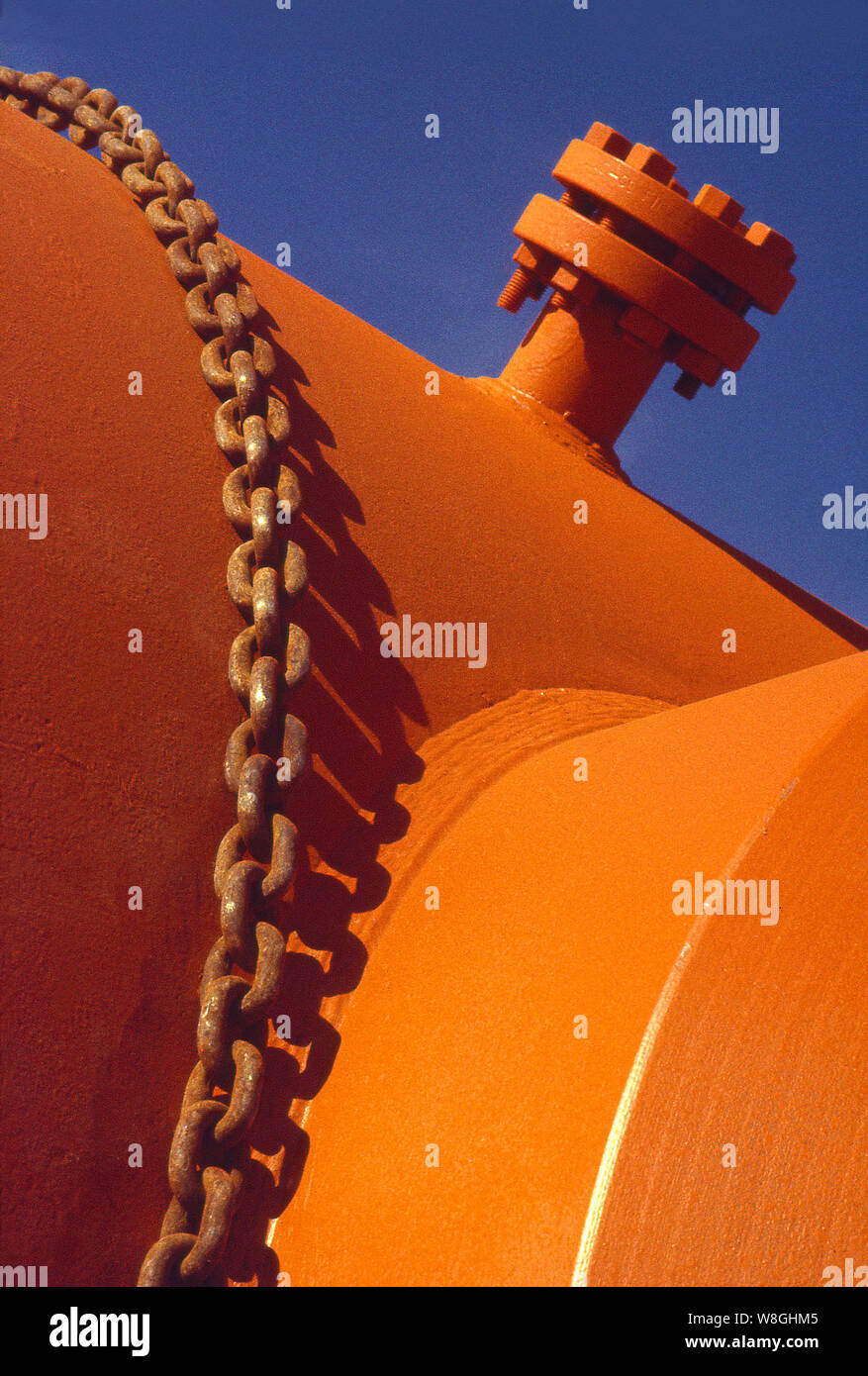 Large Orange tanks for petroleum industry chained to a transport truck ...