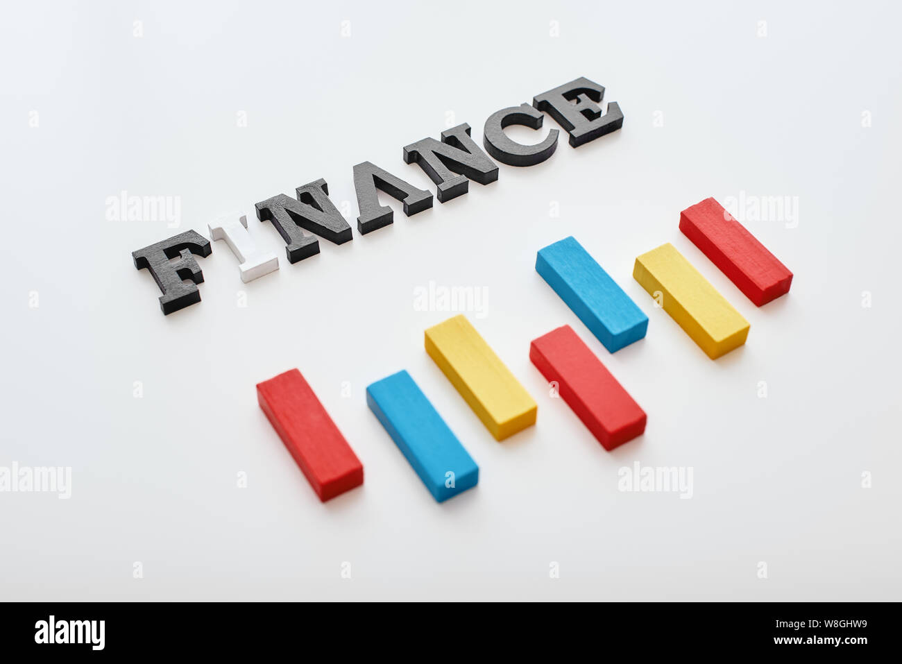 Finance word created with cubes alphabet letters near multi-colored ...