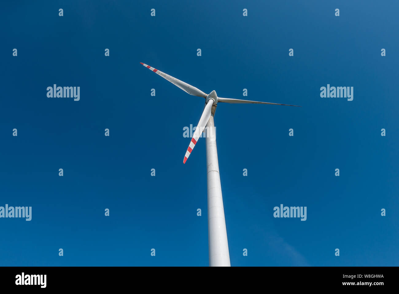 rotating blades of a windmill propeller on blue sky background. Wind ...