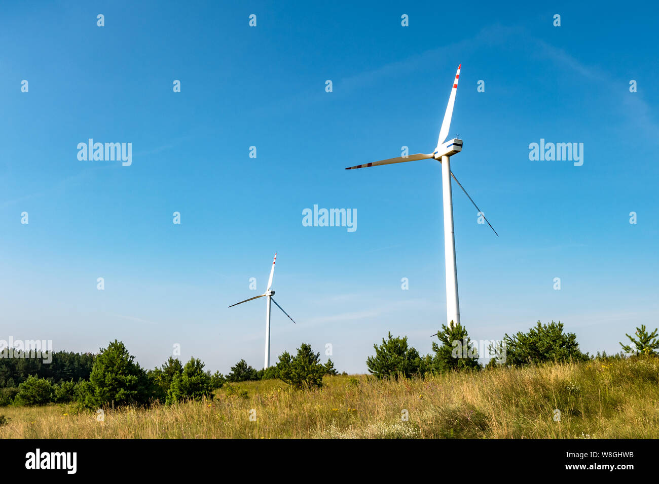 rotating blades of a windmill propeller on blue sky background. Wind ...