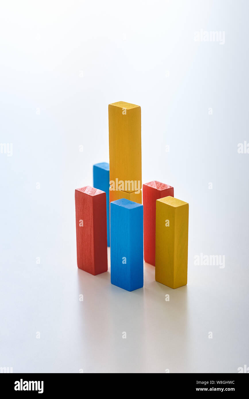 Red, blue and yellow wooden blocks of various height isolated over ...