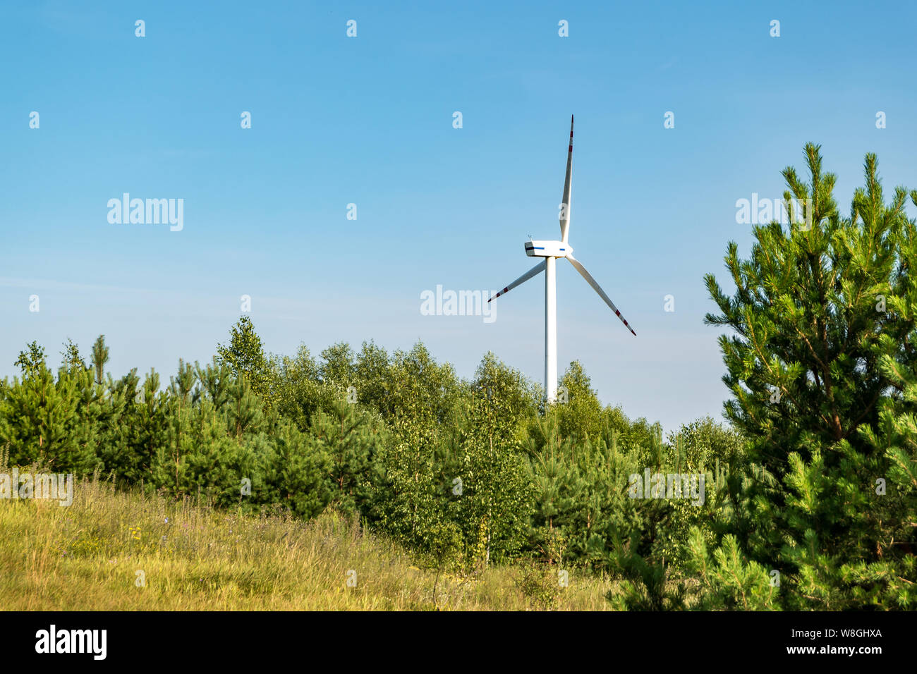 rotating blades of a windmill propeller on blue sky background. Wind ...