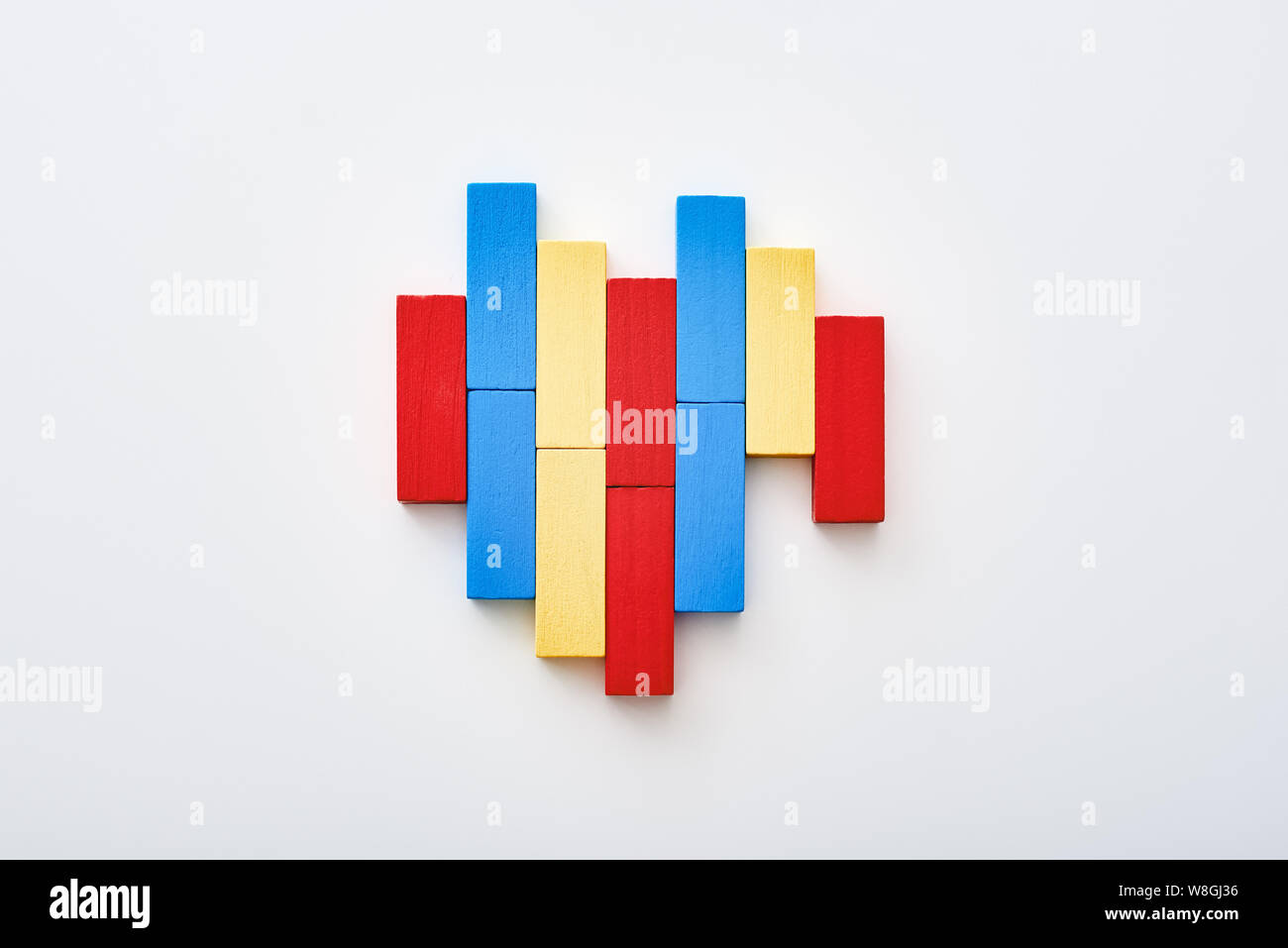Red, blue and yellow wooden blocks isolated over white background ...