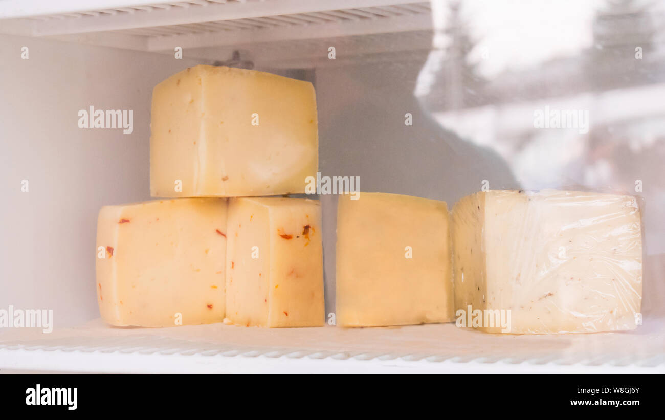 Handmade cheeses in refrigerator Stock Photo - Alamy