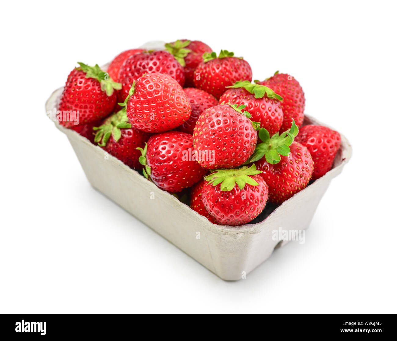 Fresh strawberry in a paper carton isolated on a white background ...
