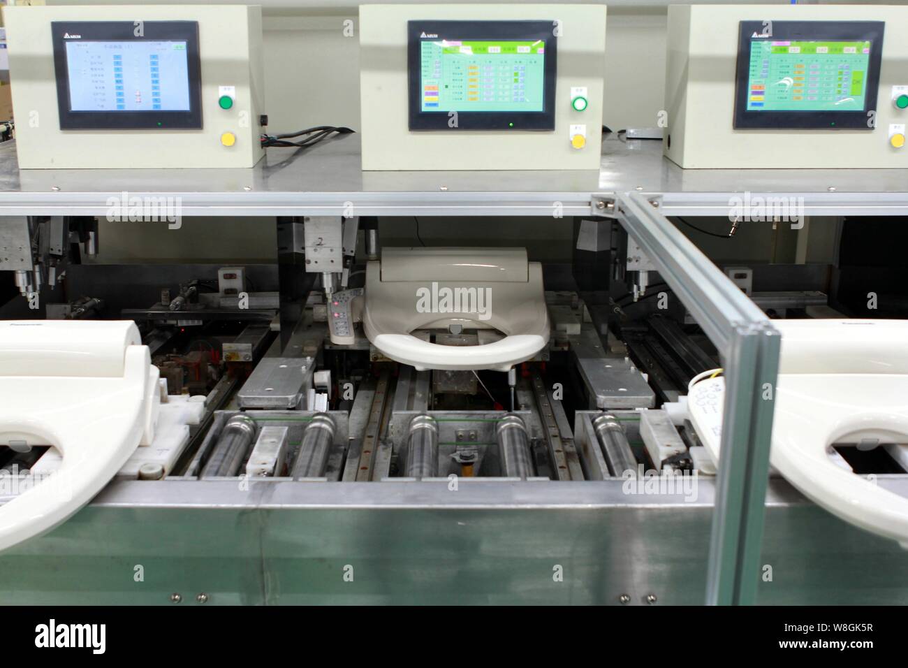 Smart toilet seats are being manufactured on the assembly line at a ...