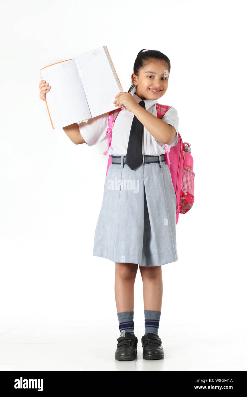 Schoolgirl showing a notebook Stock Photo - Alamy