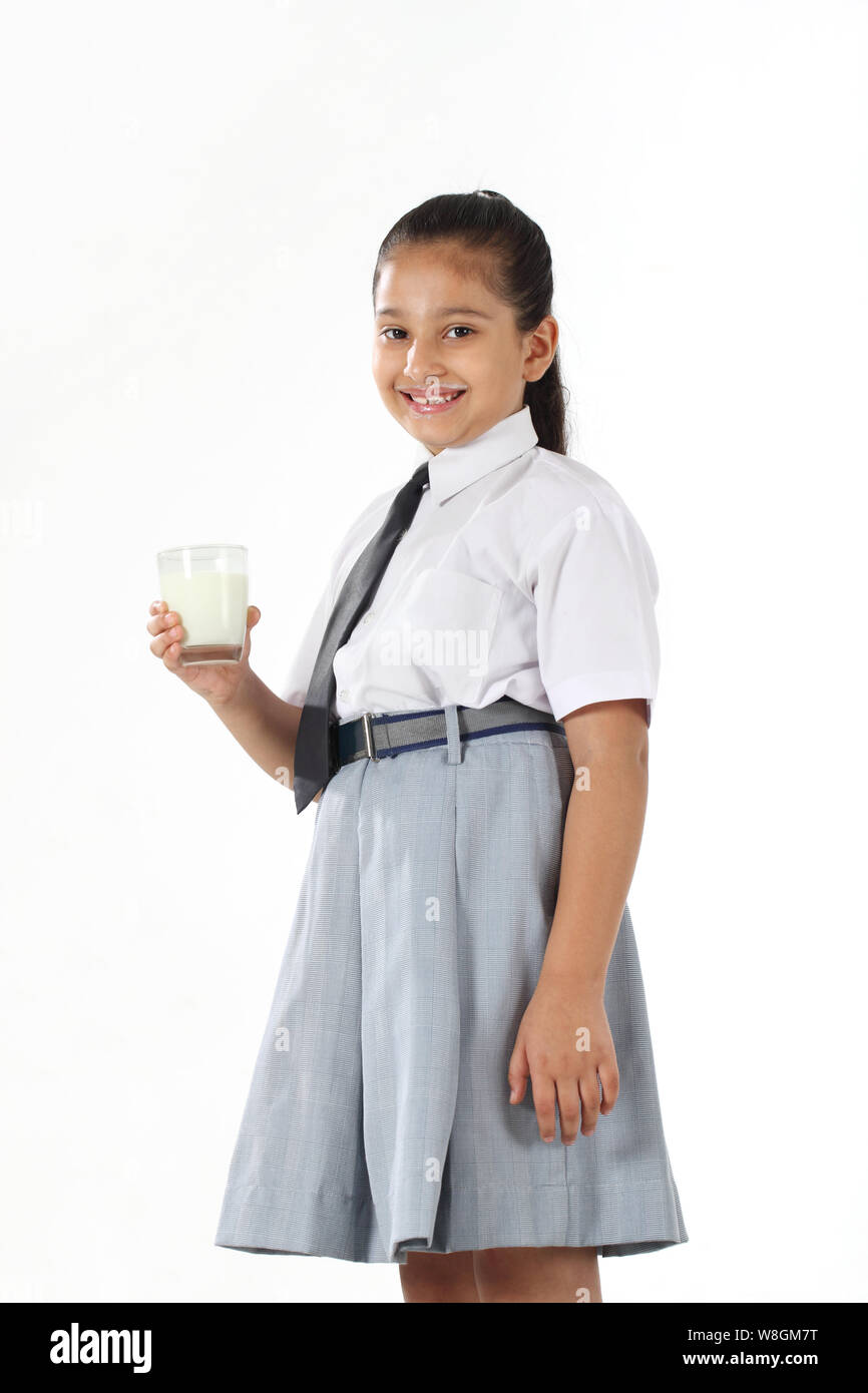 Schoolgirl drinking a glass of milk Stock Photo - Alamy