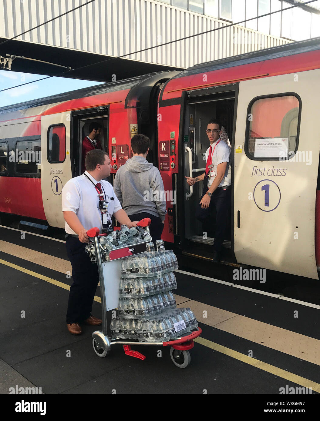A LNER staff member pushes a trolley of bottled water at Peterborough ...
