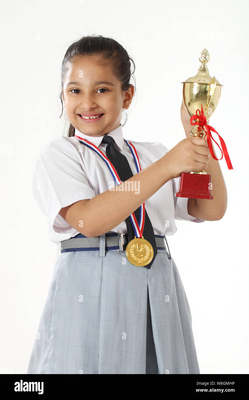 Schoolgirl holding a trophy Stock Photo - Alamy