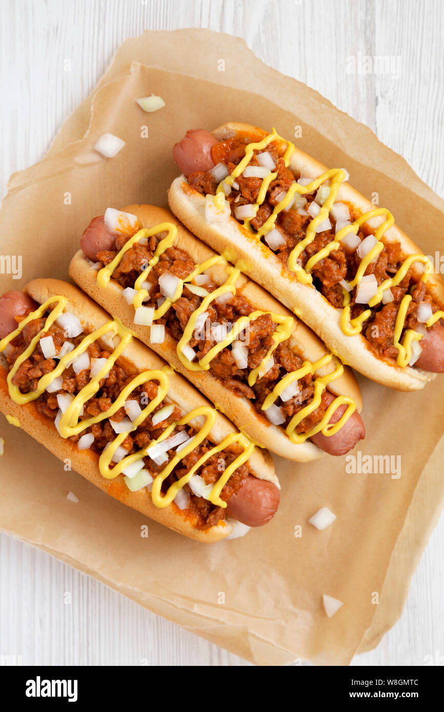 Homemade Detroit style chili dog on parchment, top view. From above ...