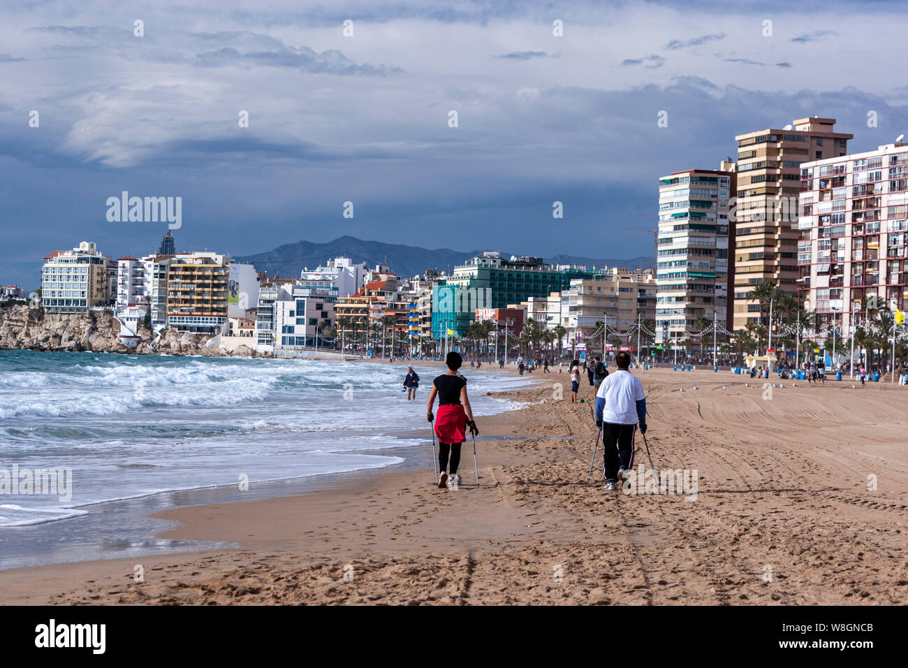 People walking along Poniente beach, Benidorm, Alicante province, Spain ...