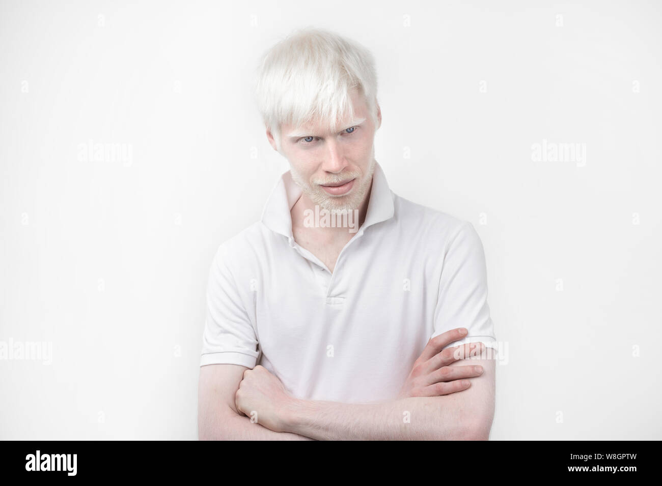 portrait of an albino man in studio dressed t-shirt isolated on a white ...