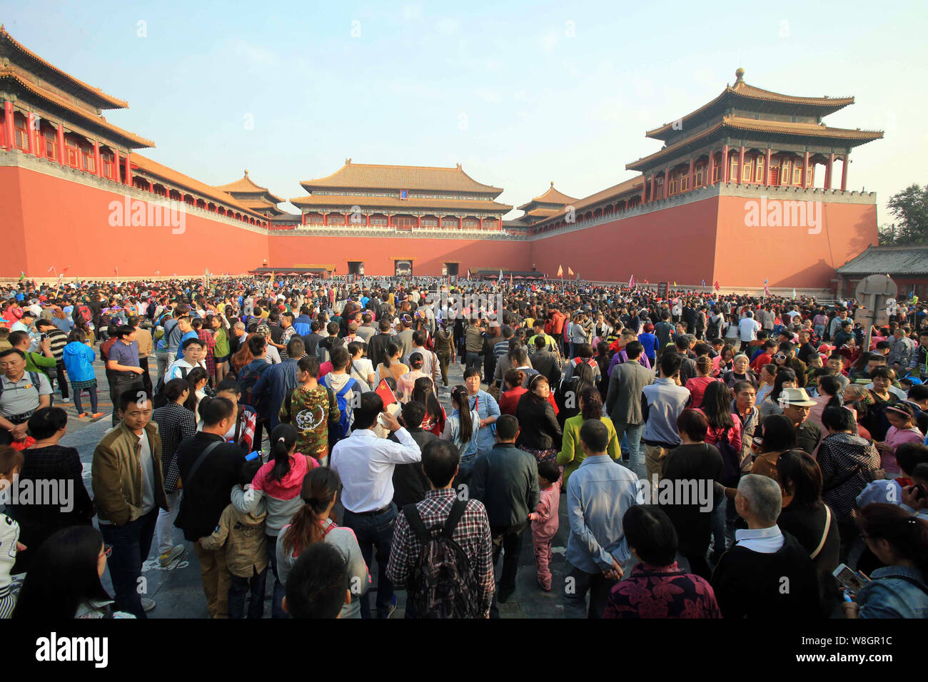 Crowds of tourists queue up to enter the Forbidden City during the week ...