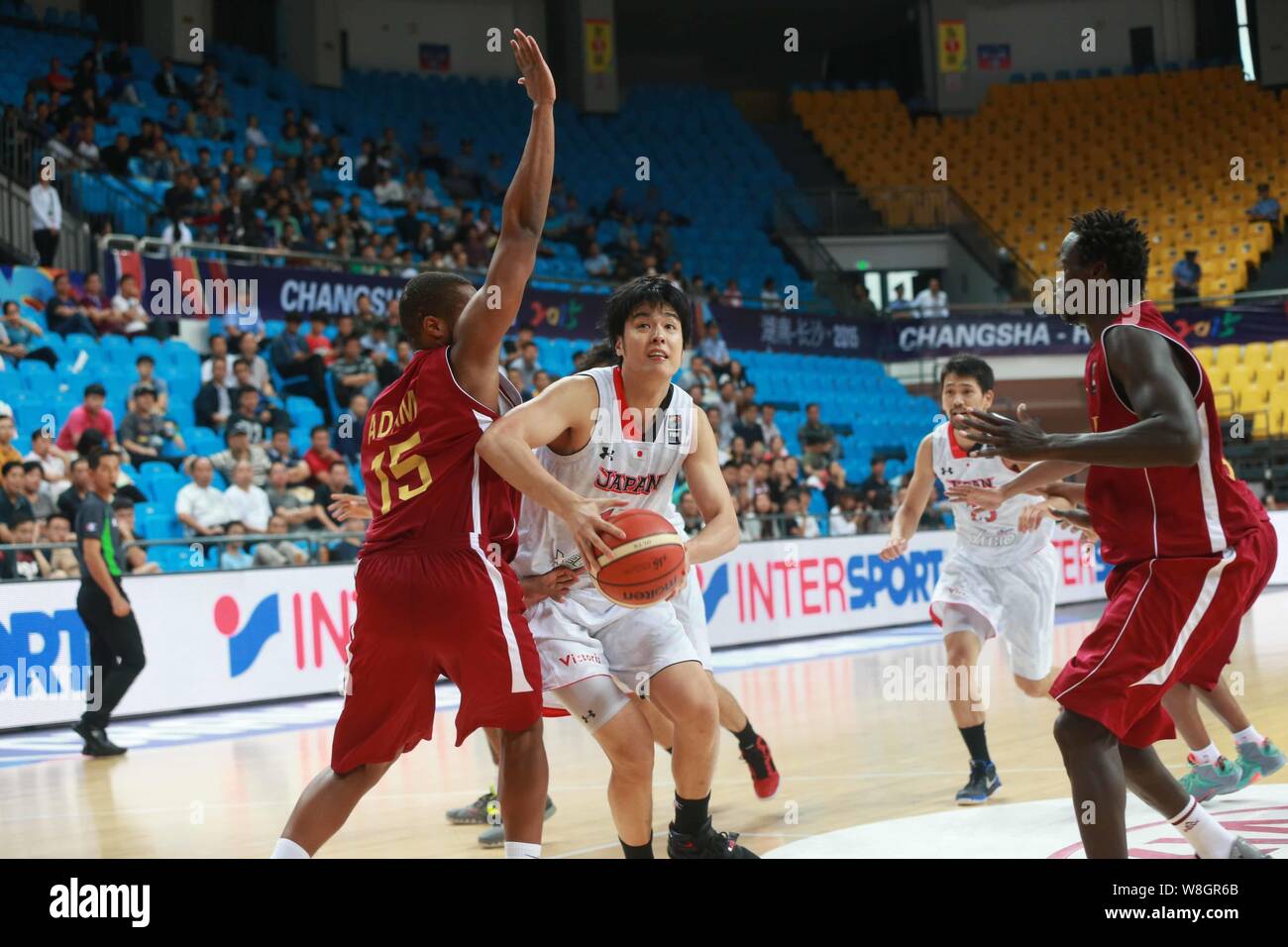 Joji Takeuchi of Japan, center, prepares to drive to the basket against ...