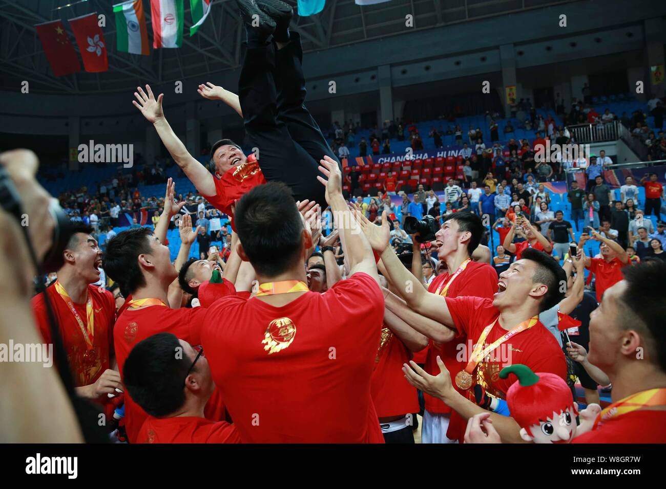 Players of China celebrate after defeating the Philippines at the award ...