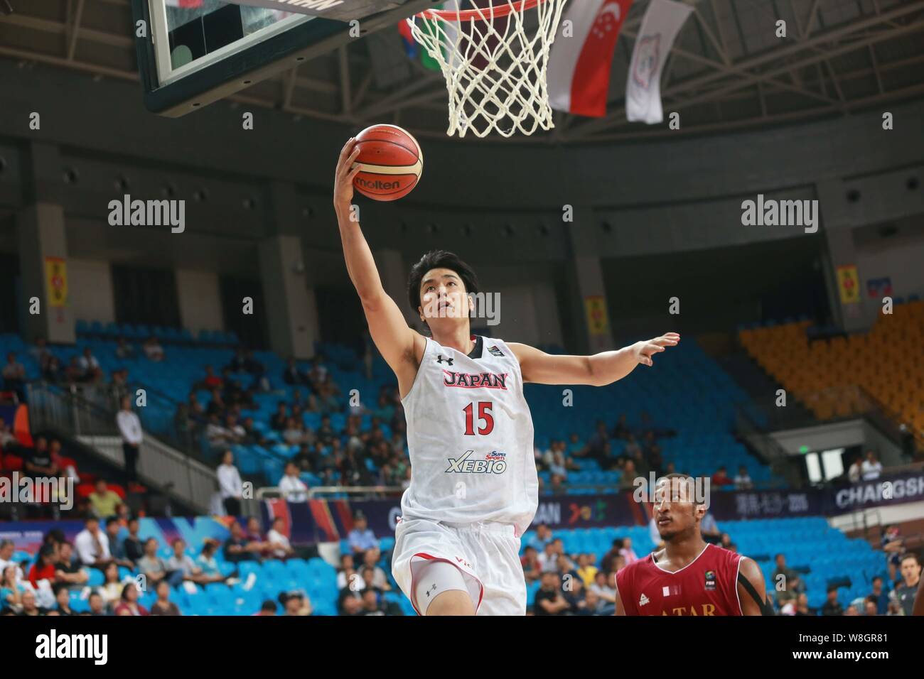 Joji Takeuchi of Japan drives to the basket against Qatar in a quarter ...