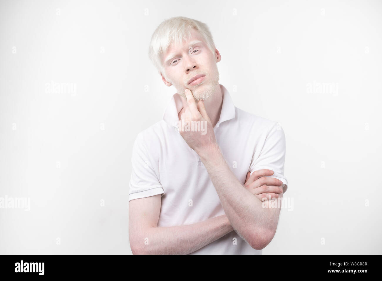 portrait of an albino man in studio dressed t-shirt isolated on a white ...