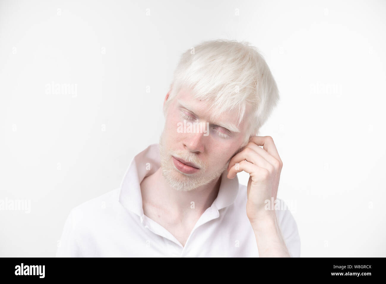portrait of an albino man in studio dressed t-shirt isolated on a white ...