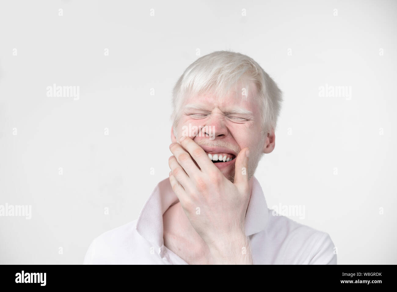 portrait of an albino man in studio dressed t-shirt isolated on a white ...
