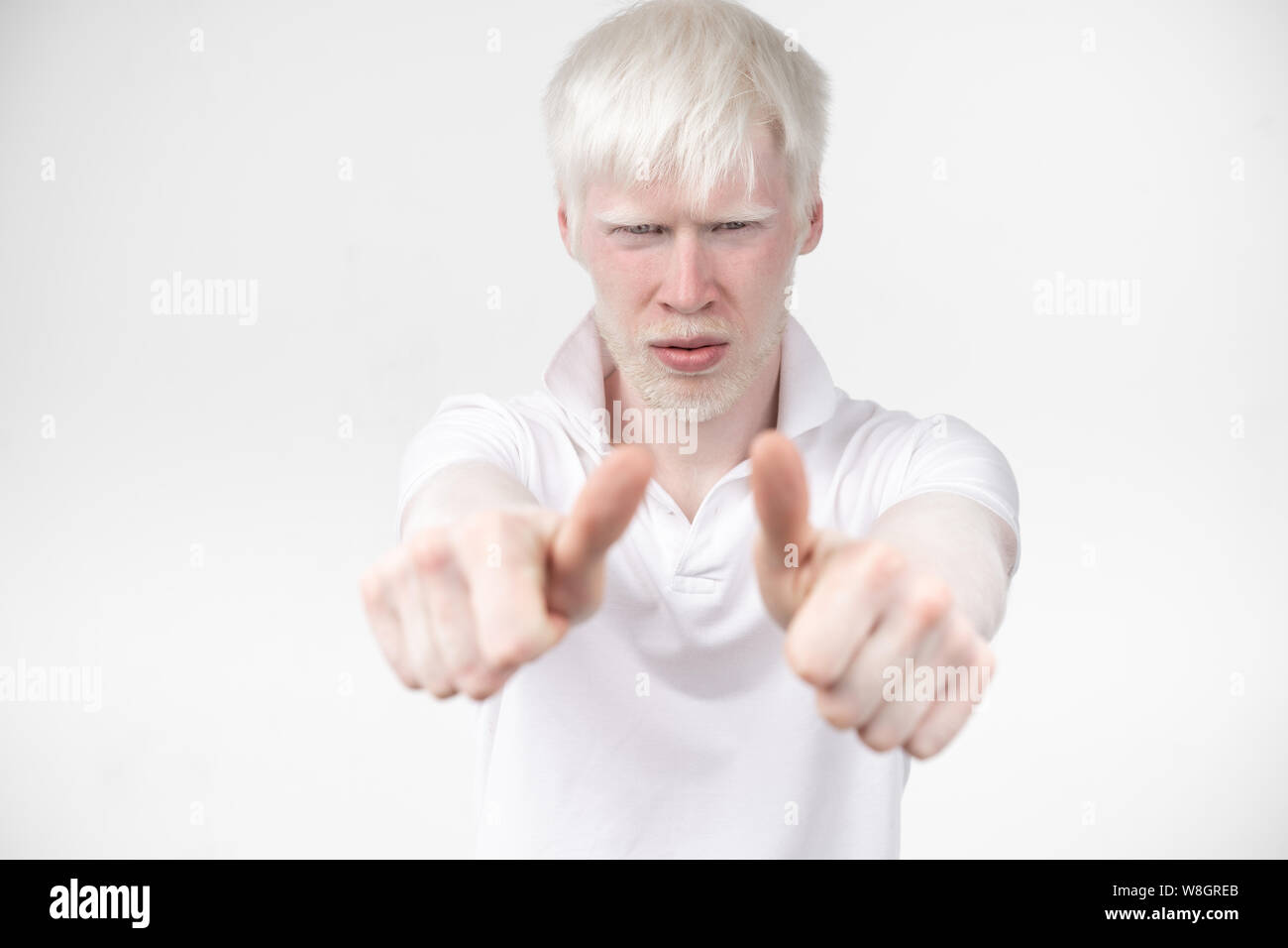 portrait of an albino man in studio dressed t-shirt isolated on a white ...