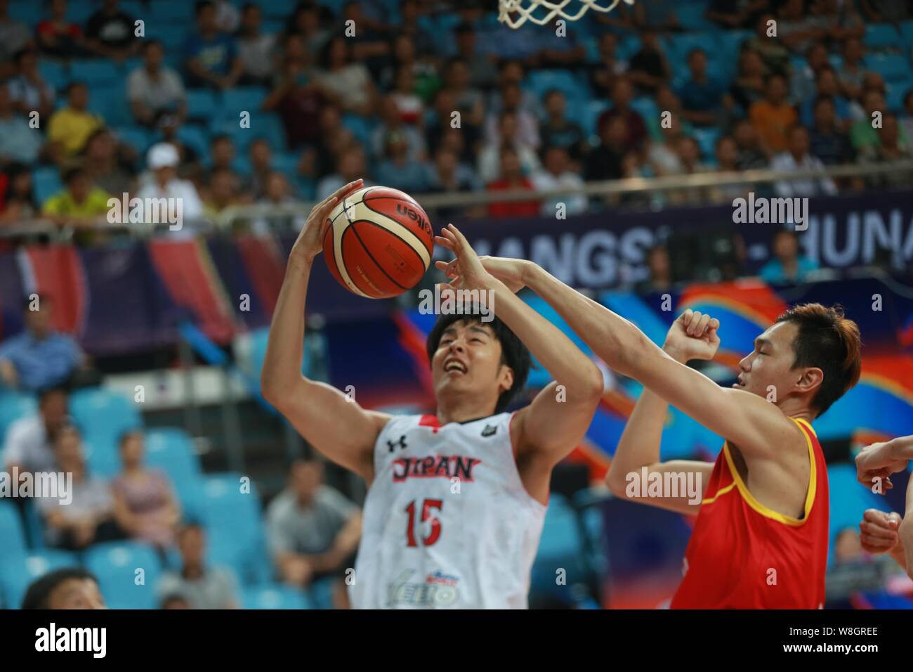 A player of Malaysia, right, challenges Joji Takeuchi of Japan in a ...