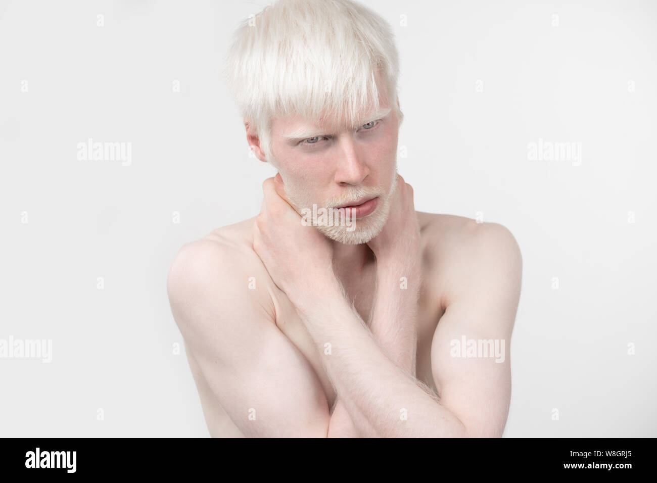 portrait of an albino man in studio dressed t-shirt isolated on a white ...