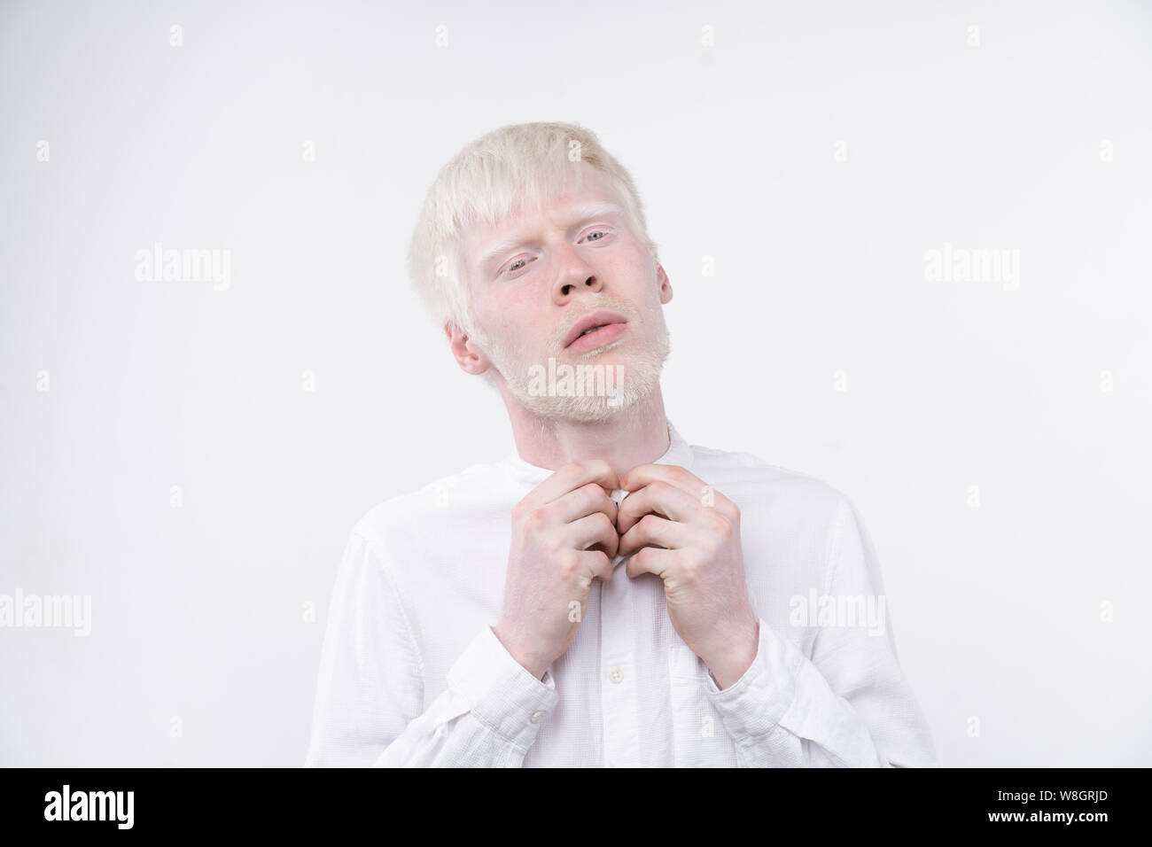 portrait of an albino man in studio dressed t-shirt isolated on a white ...