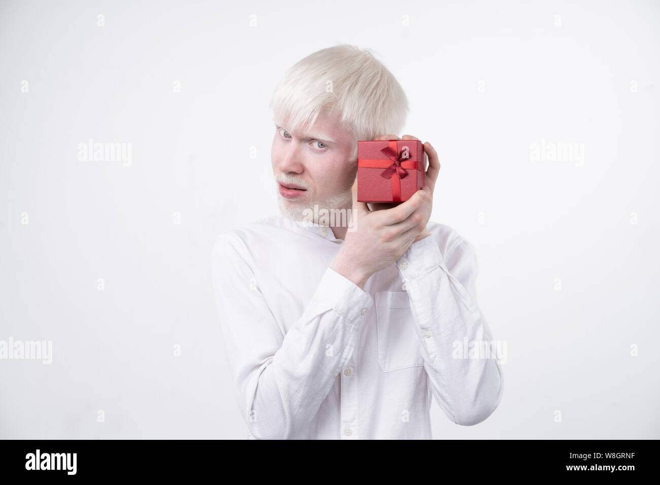 portrait of an albino man in studio dressed t-shirt isolated on a white ...