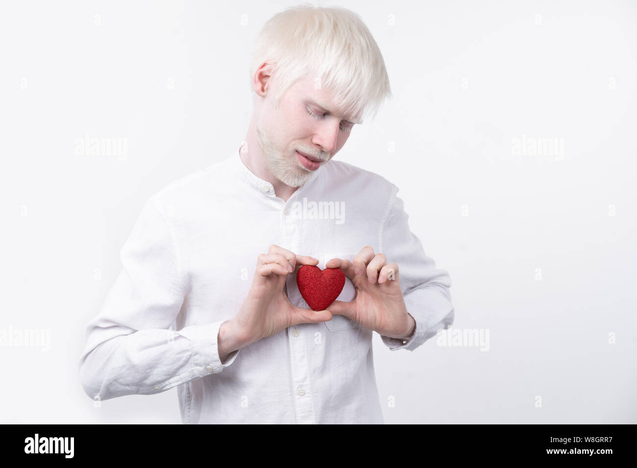 portrait of an albino man in studio dressed t-shirt isolated on a white ...